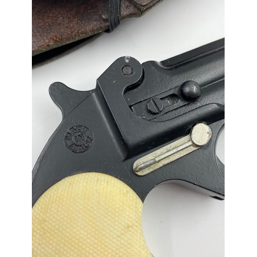A Umarex 6mm Derringer Blank Firing Pistol with leather Holster