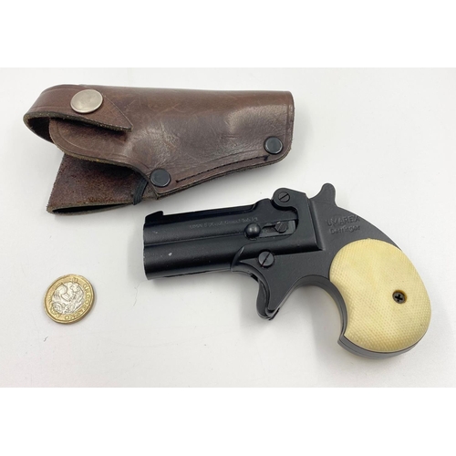 A Umarex 6mm Derringer Blank Firing Pistol with leather Holster