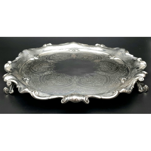 A 761gms solid silver Salva with scrolled edges and hand chased ...