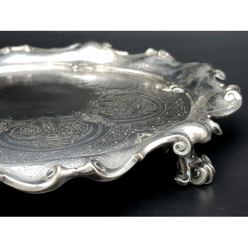 A 761gms solid silver Salva with scrolled edges and hand chased ...