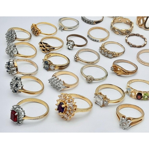 A Bundle of 34 gold-toned costume jewellery rings, some stone set ...