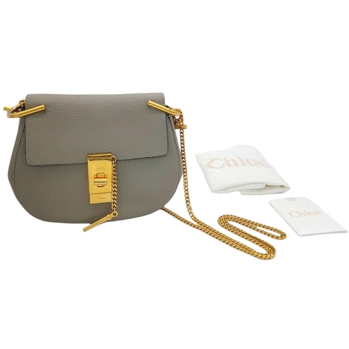 A Chloé Drew Shoulder Bag. Grained grey leather exterior with gold ...