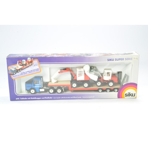 Siku 1/55 diecast model truck issue comprising no. 3911 low loader with excavator and wheel loader.