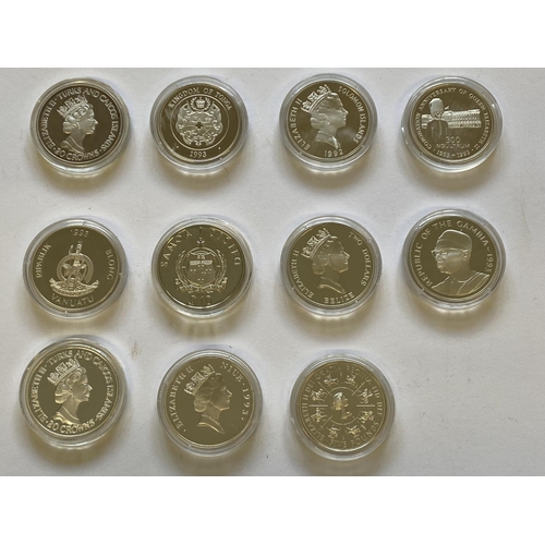 A COLLECTION OF SILVER PROOF WORLD COINS. A collection of Crown sized ...