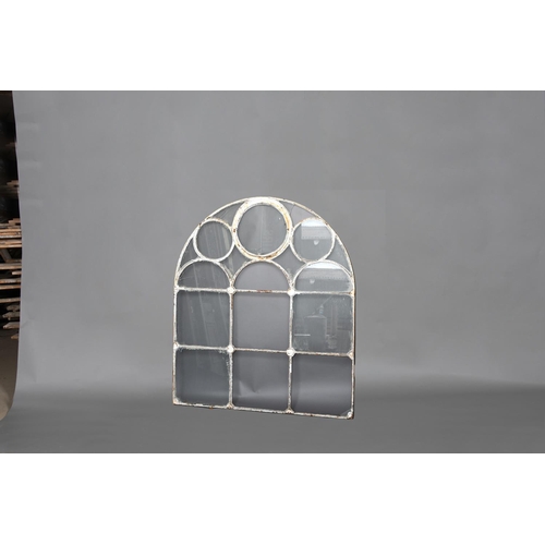 A CAST IRON 19TH CENTURY ROSETTE WINDOW FRAME. with bullseye opening ...