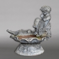 A LEAD CHERUB BIRD BATH. on a shell bowl, height 39cm, width 40cm ...