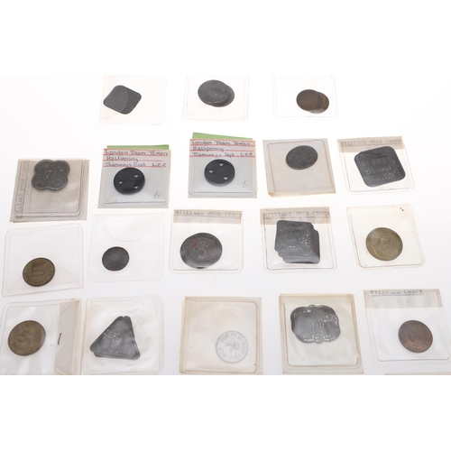 A MIXED COLLECTION OF ASSORTED BRASS TICKETS AND TOKENS. A collection ...