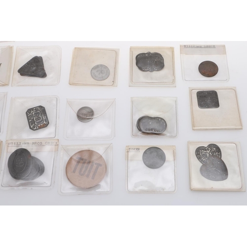 A MIXED COLLECTION OF ASSORTED BRASS TICKETS AND TOKENS. A collection ...