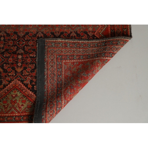 A MALAYIR RUG, WEST IRAN, CIRCA 1920. the deep indigo serrated Herati ...