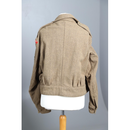 A COLLECTION OF SECOND WORLD STYLE BATTLE TUNICS AND TROUSERS. A ...