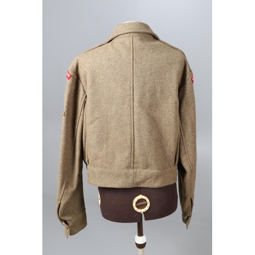 A COLLECTION OF SECOND WORLD STYLE BATTLE TUNICS AND TROUSERS. A ...