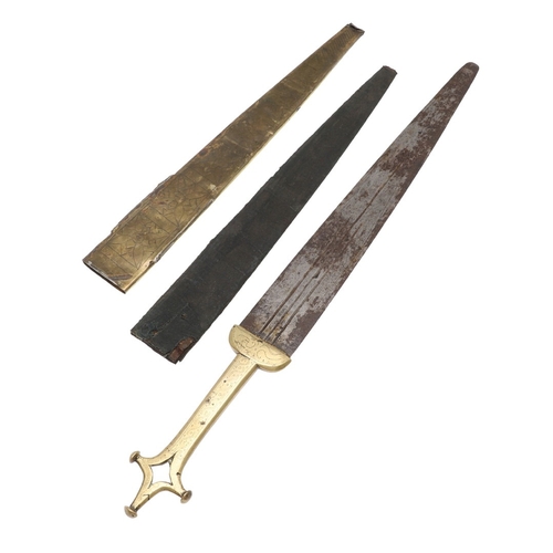A NORTH AFRICAN DAGGER AND SCABBARD WITH DECORATIVE BRASS HANDLE. With ...
