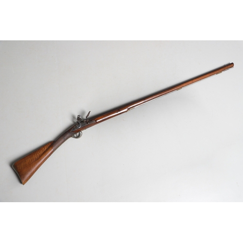 A FLINTLOCK FOWLING GUN BY THOMAS. With a 101 cm barrel tapering from ...