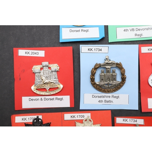 A COLLECTION OF TWELVE DEVON AND DORSET REGIMENT BADGES. A collection ...