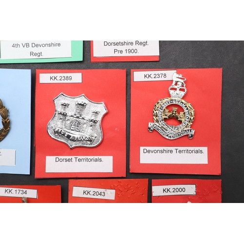 A COLLECTION OF TWELVE DEVON AND DORSET REGIMENT BADGES. A collection ...