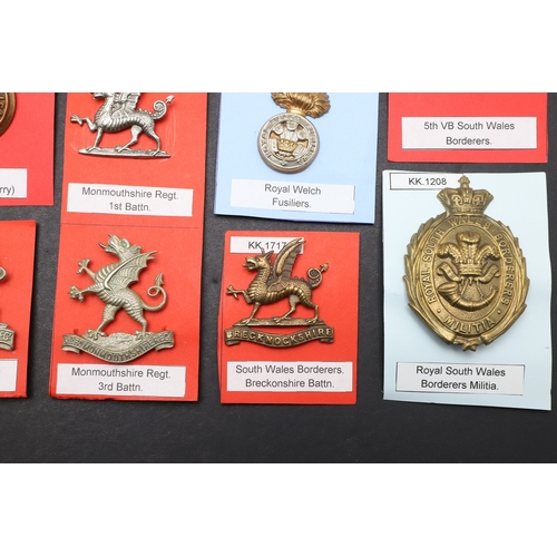 A COLLECTION OF EIGHTEEN BADGES FOR WELSH REGIMENTS. A collection of ...