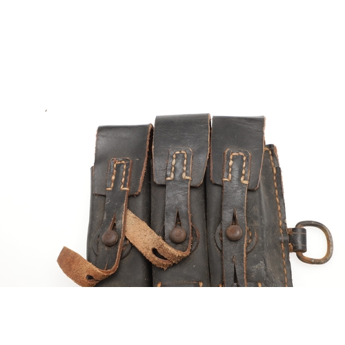 A GERMAN SUBMACHINE GUN MAGAZINE POUCH. A magazine pouch for three ...