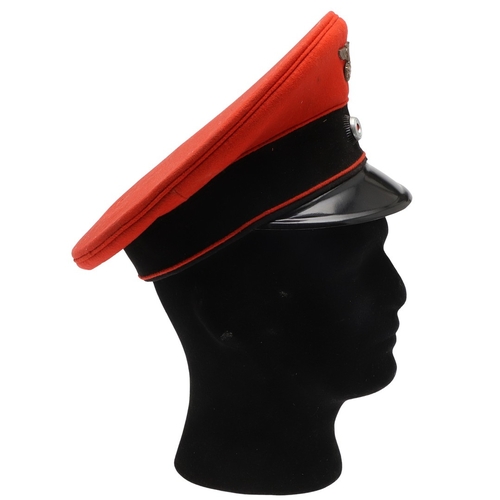 A SECOND WORLD WAR GEMAN NATIONAL RAILWAY PEAKED CAP. A red peaked cap ...