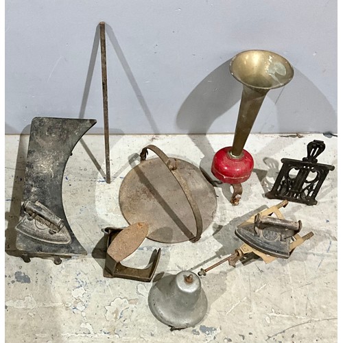BOX OF ASSORTED FLAT IRONS, POT STANDS, WESTINGHOUSE BELL AND KLAXON