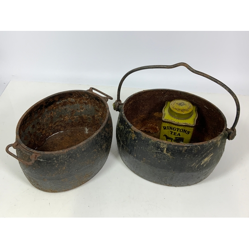 2 CAST IRON RANGE POTS & A RINGTONS TEA TIN