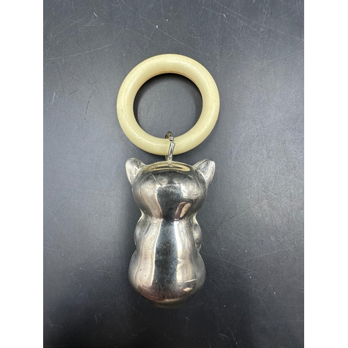 A vintage cat shaped white metal teething rattle