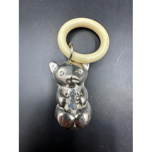 A vintage cat shaped white metal teething rattle