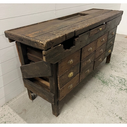 A rustic work bench with brass cup handles (H80cm W153cm D46cm)