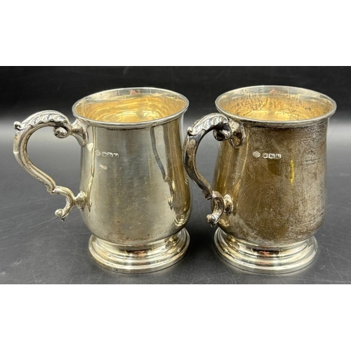 Two engraved silver tankards, with an approximate combined weight of ...