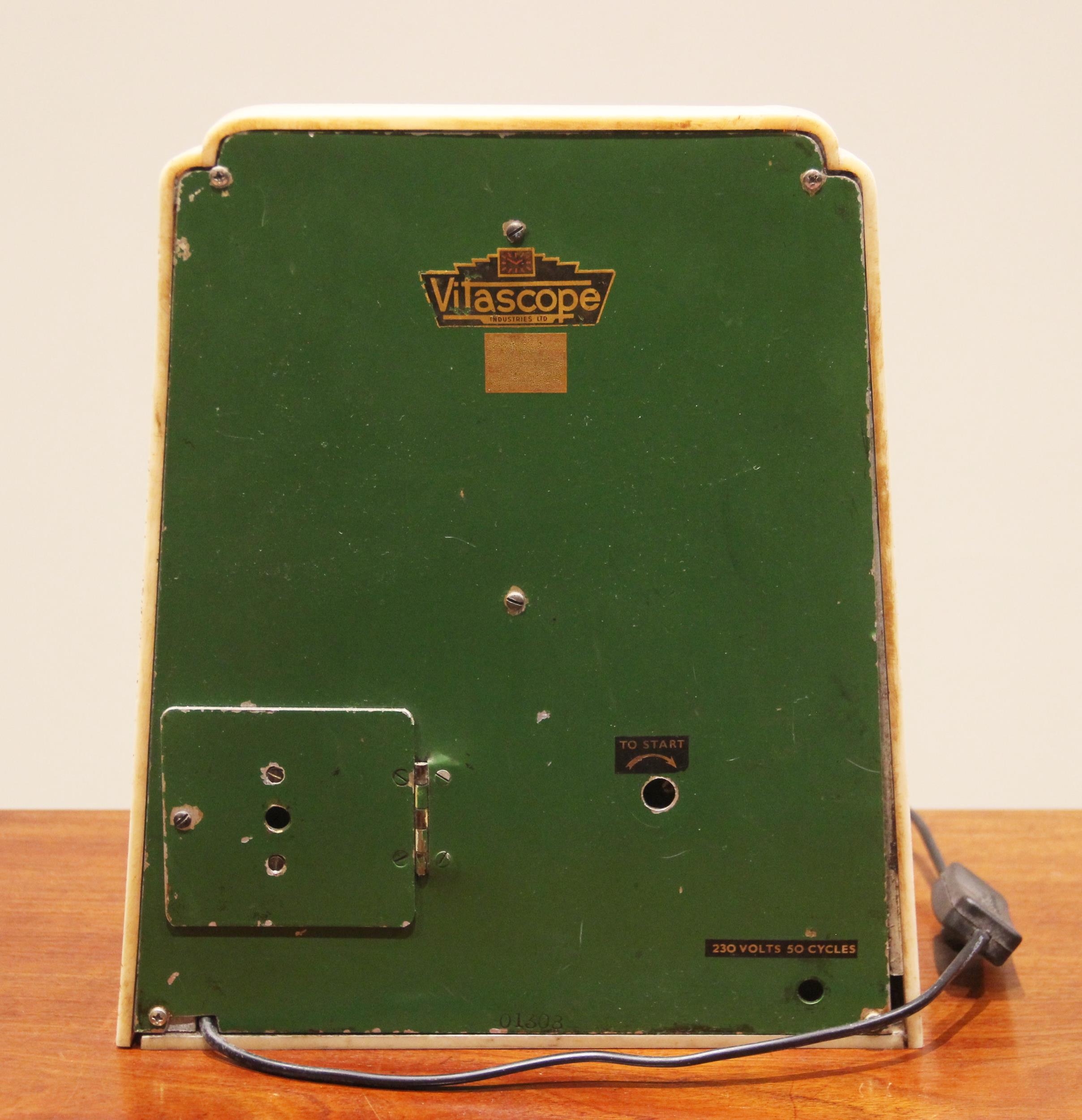 A 1940's Vitascope Industries Ltd pink Bakelite clock, with a sailing ...