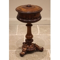 A Victorian oak Puginesque teapoy, the hinged drum shaped top with a ...