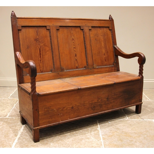 A Victorian pitch pine box settle, the three panel back applied with ...