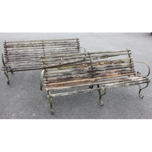 A pair of slatted wrought iron garden benches, early 20th century, each ...
