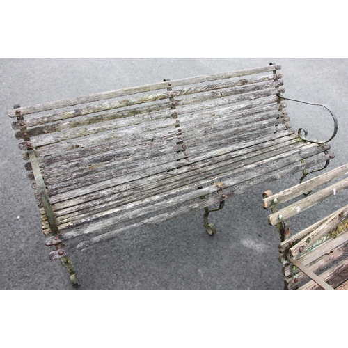 A pair of slatted wrought iron garden benches, early 20th century, each ...
