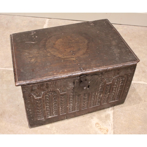 A 17th century carved oak carriage or bible box, the hinged cover with ...