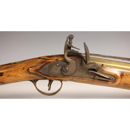 A reproduction flintlock blunderbuss, the round bronze barrel stamped ...