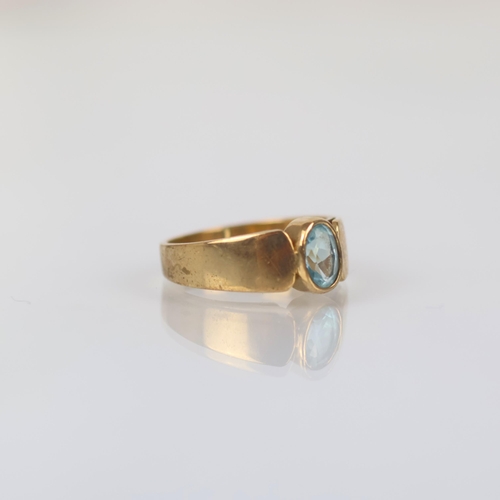 A late 20th century 9ct gold dress ring, the central oval cut topaz ...