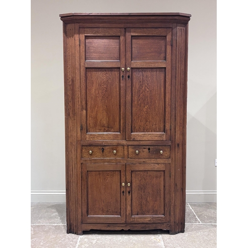 A George III oak floor standing, full height corner cupboard, the upper ...