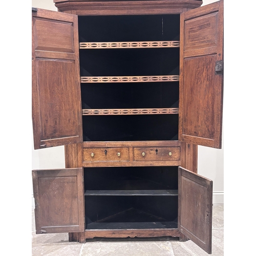 A George III oak floor standing, full height corner cupboard, the upper ...