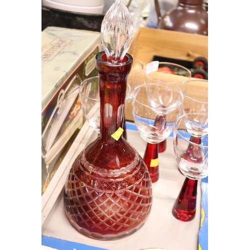 Red cut glass decanter with 6 red stemmed wine glasses