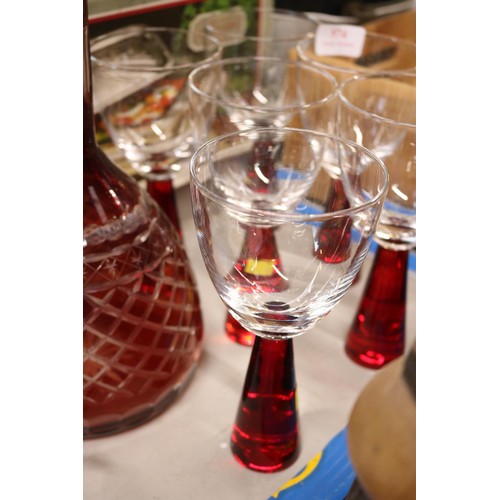 Red cut glass decanter with 6 red stemmed wine glasses