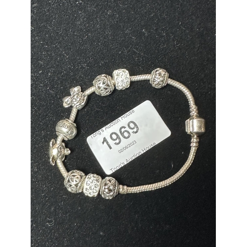 Pandora style charm bracelet stamped 925 with nine charms including ...