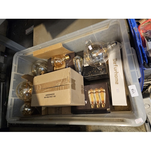 Very large clear plastic storage box containing various types of light ...