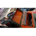 collection of vinyl records and an orange storage box.
