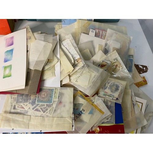 Collection of stamp albums, loose stamps and mail related postcards.