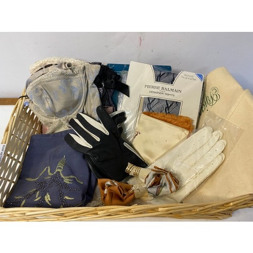 Basket of vintage lace basques, tights, leather gloves, laundry and PJ ...