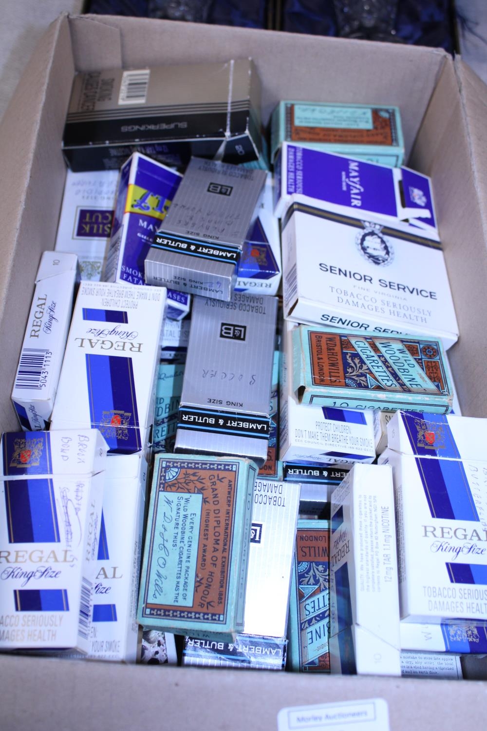 A box full of vintage cigarette collectors cards and empty boxes