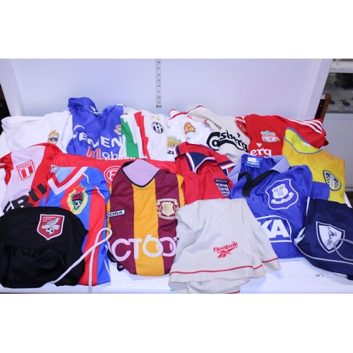 A selection of assorted adult size football shirts