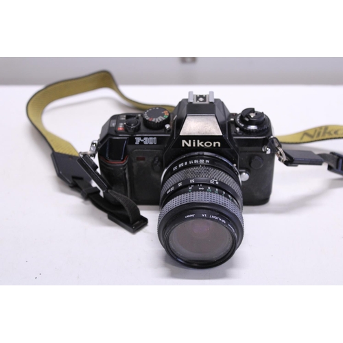 A vintage Nikon F-301 35mm camera and lens