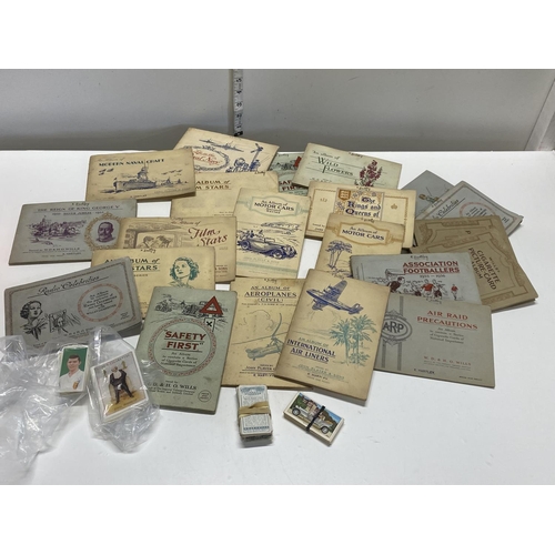 A selection of cigarette cards albums and cards