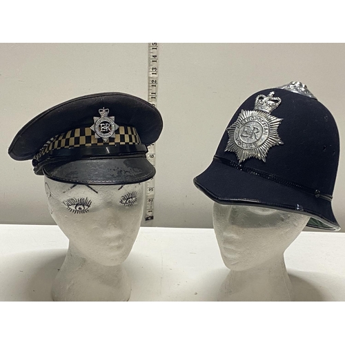 Two vintage Metropolitan police helmets